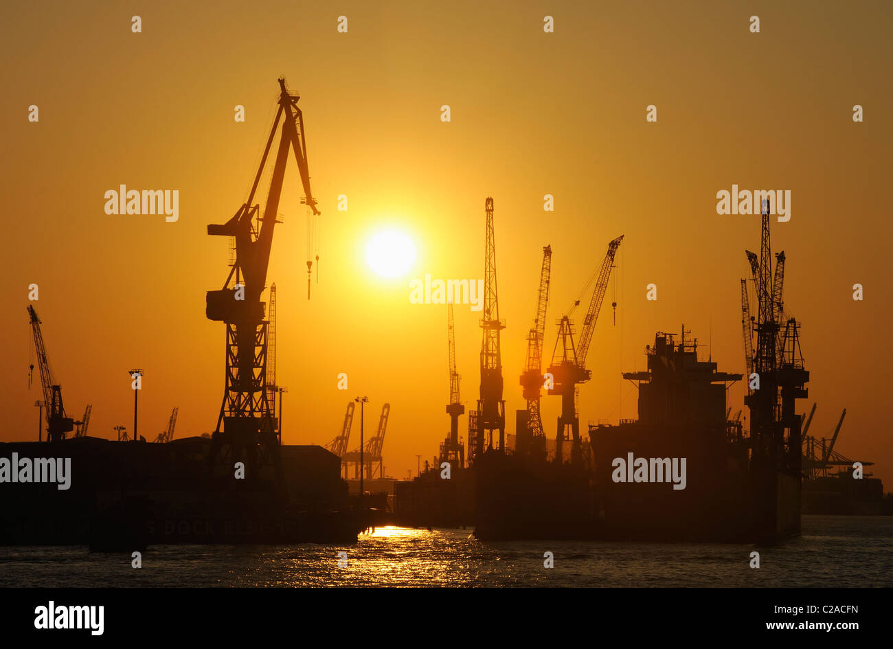 Ship in dry dock and cranes at sunset, Hamburg, Germany Stock Photo - Alamy