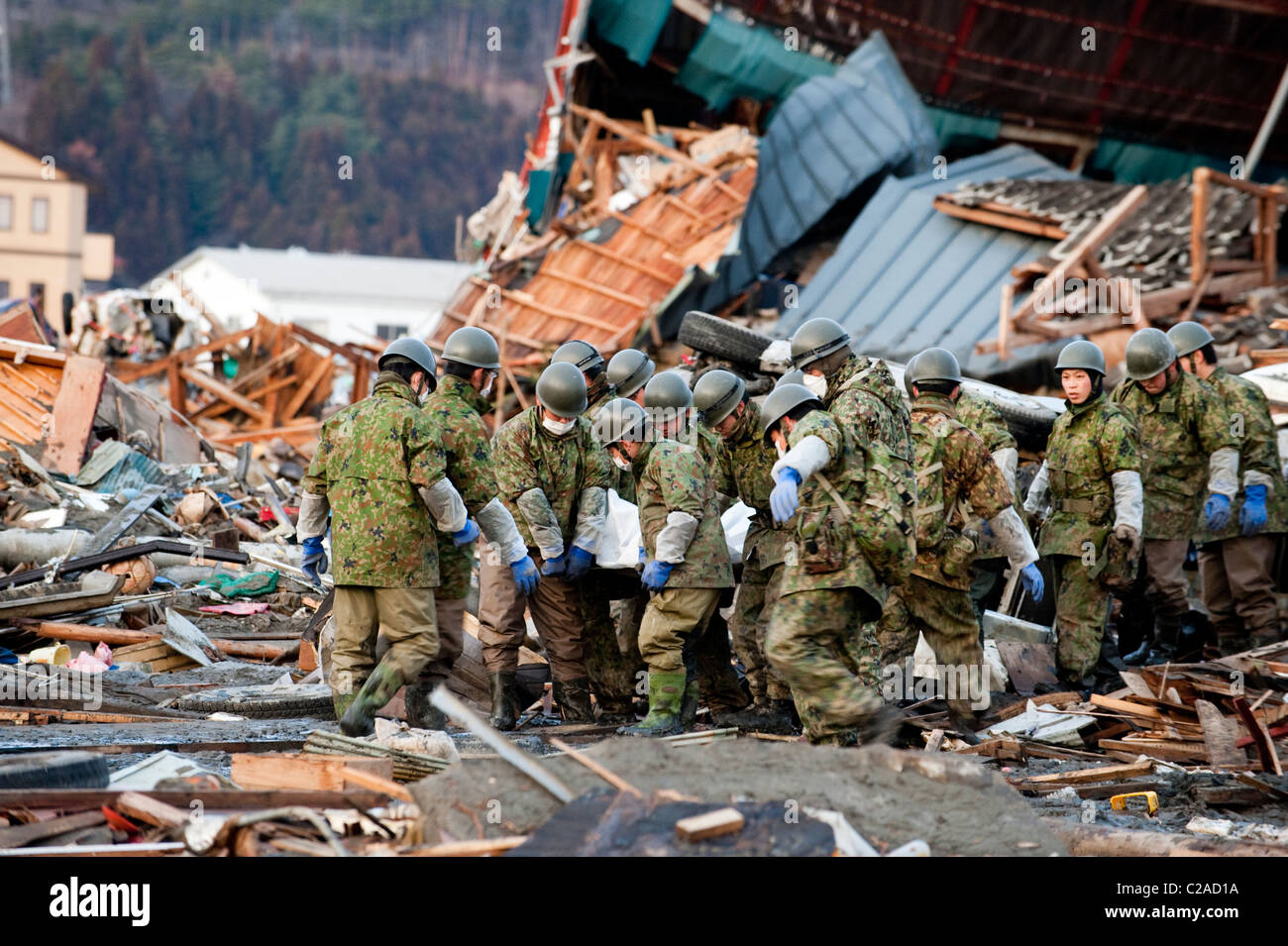 JSDF remove a body after thousands of homes, boats and people were ...