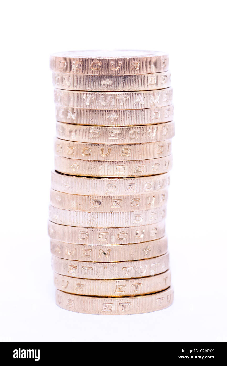 A stack of English currency one pound ( £1 ) coins on a white ...