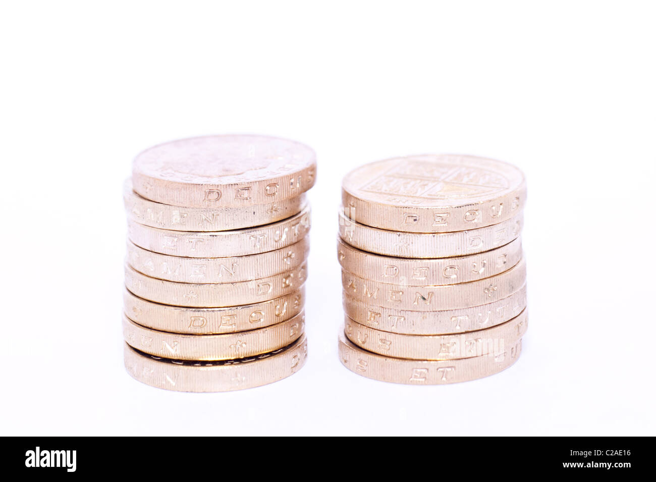 A stack of English currency one pound ( £1 ) coins on a white ...