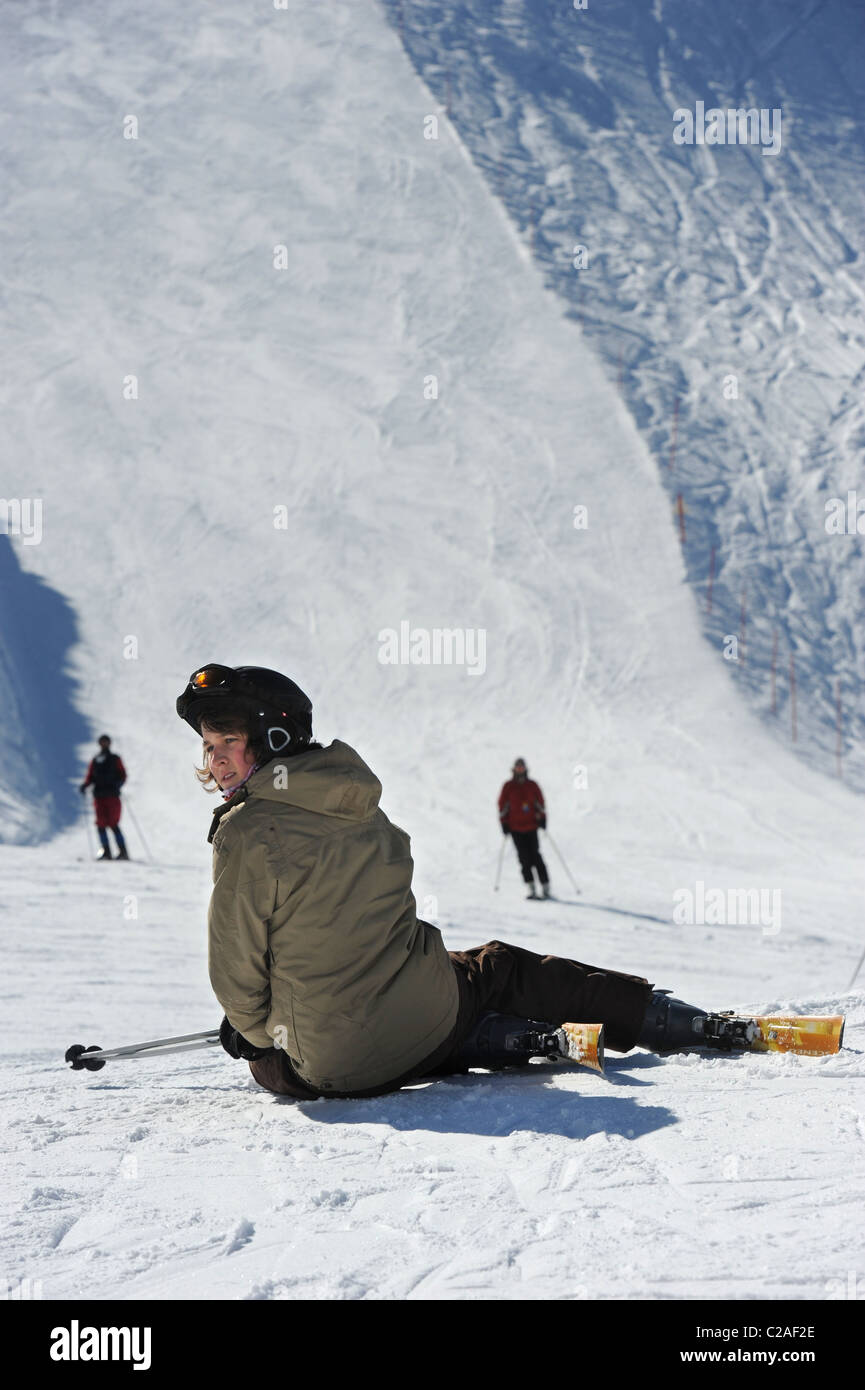 A boy rests after a skiing fall at the Vogel Ski Centre on the the Sija ...