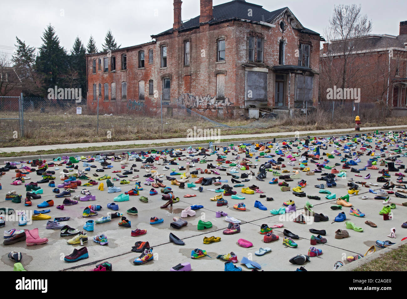Art exhibit of thousands of shoes on the street represents the issue of ...