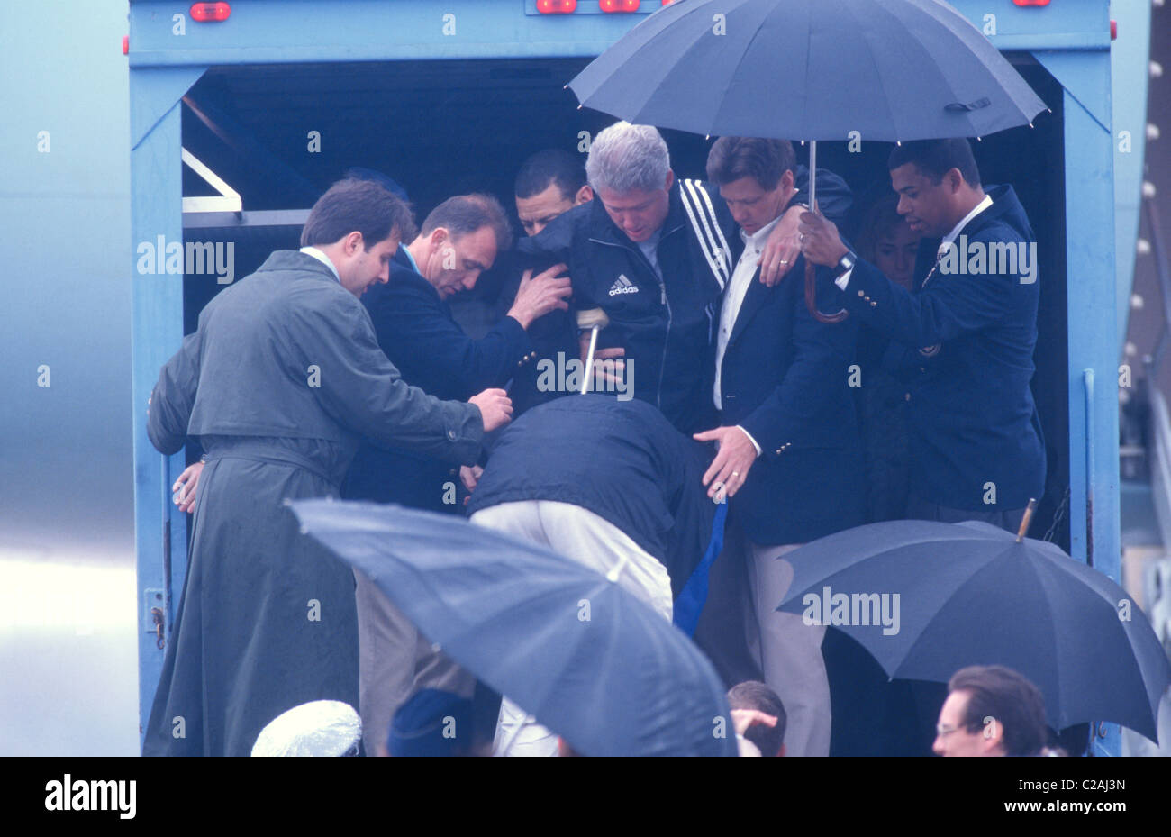 President Bill Clinton is helped out of a truck at Andrews AFB after ...