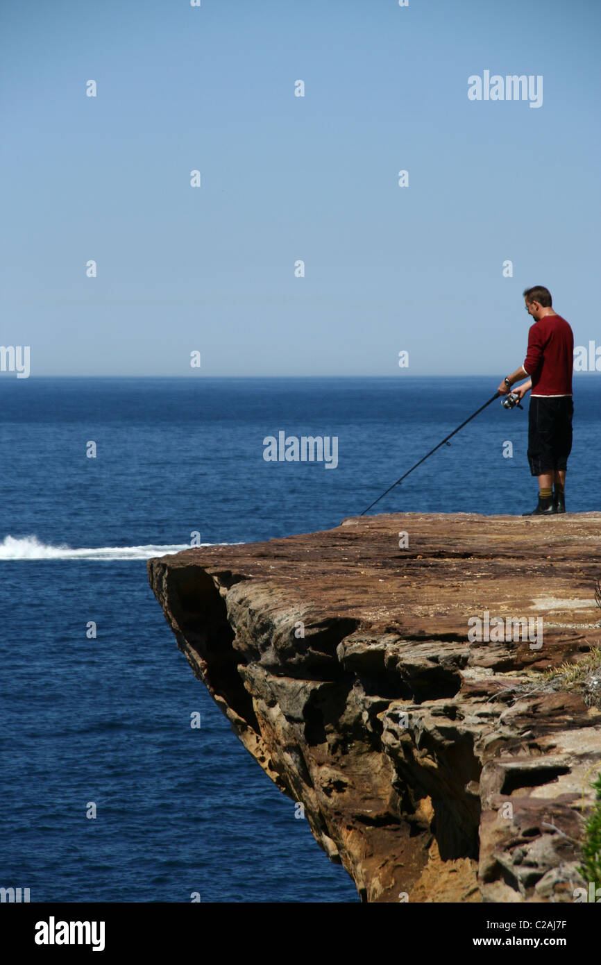 Man fishing from cliff top in Sydney Stock Photo - Alamy