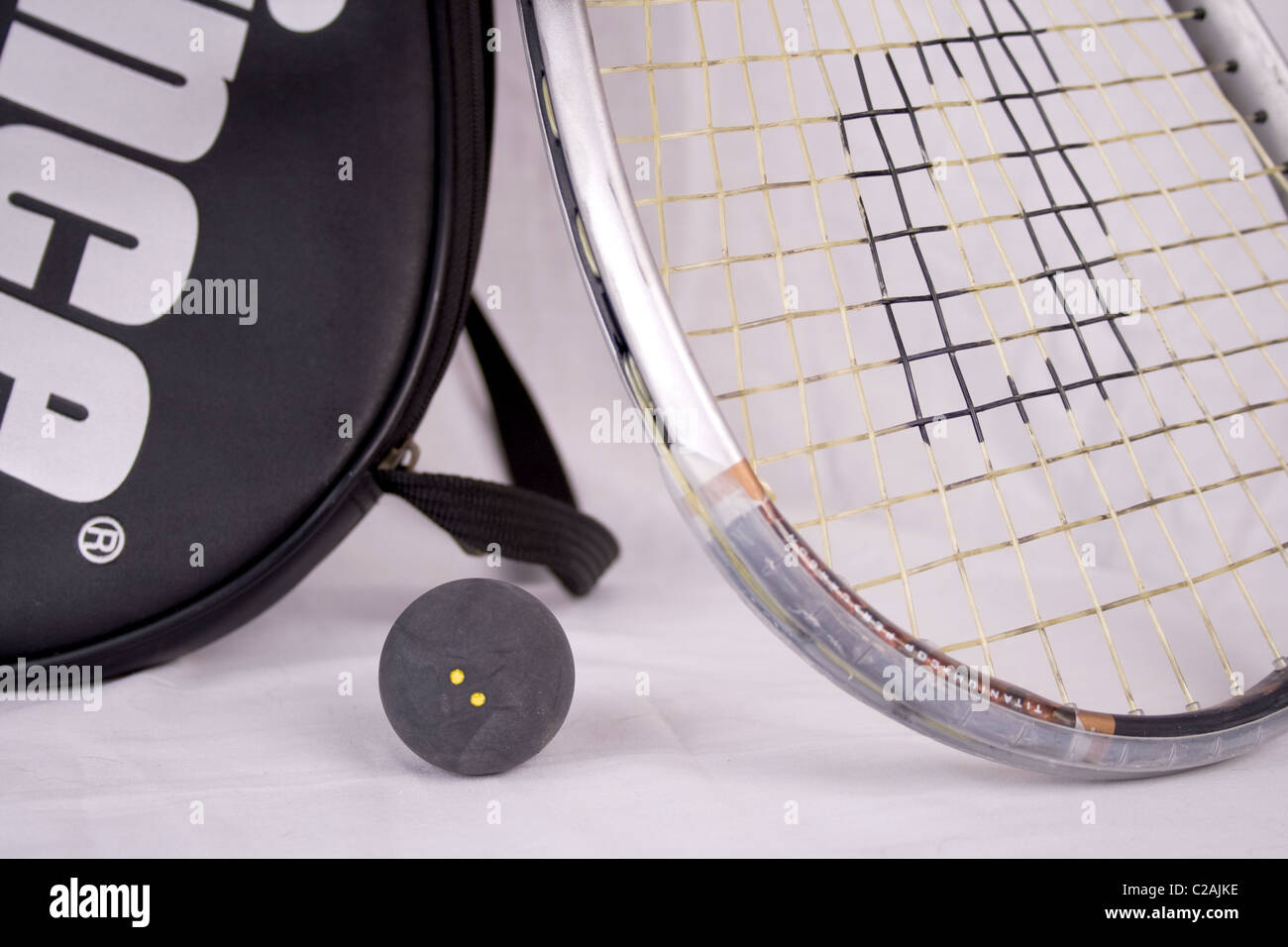 Squash racquet, racquet case and double yellow ball Stock Photo - Alamy