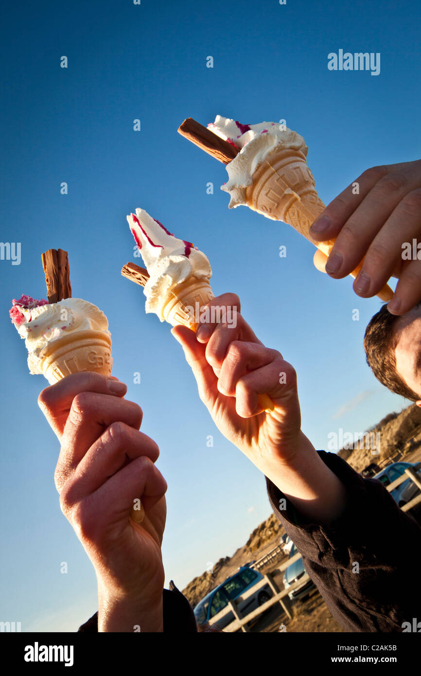Hands holding up three Ice creams Stock Photo - Alamy