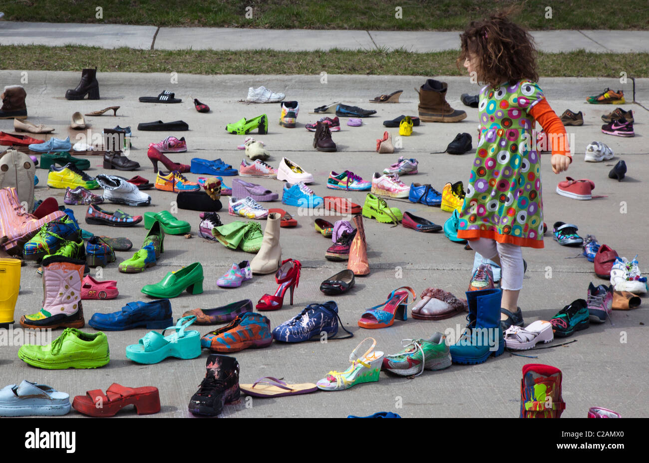 Art exhibit of thousands of shoes on the street represents the issue of ...