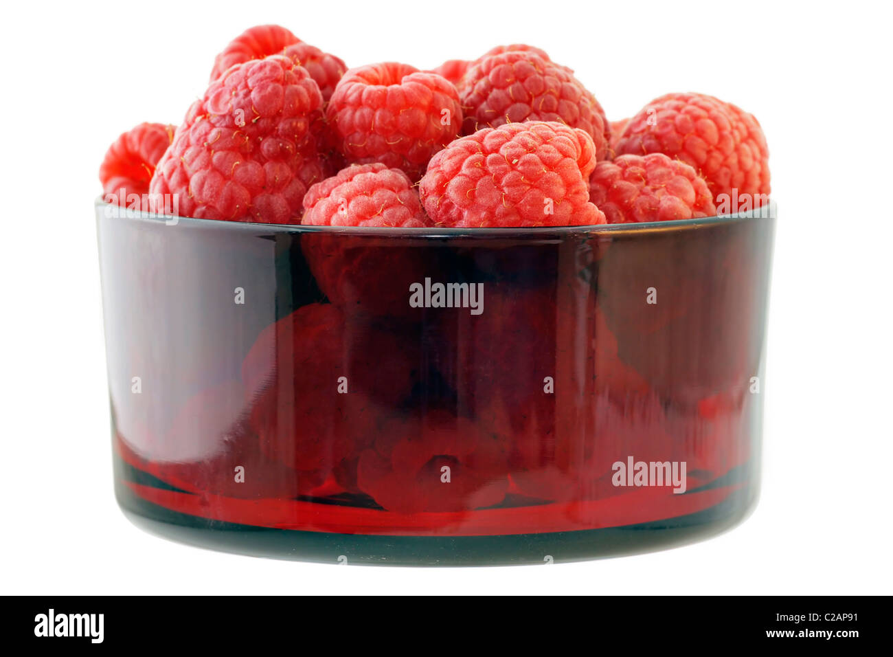 Sweet and delicious raspberries in a vintage red colored glass bowl ...