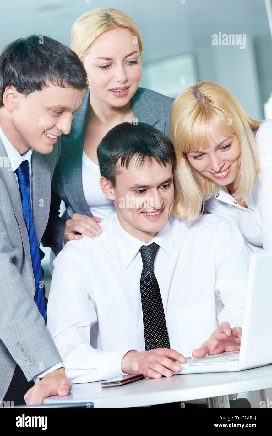 Four business people working in office Stock Photo - Alamy