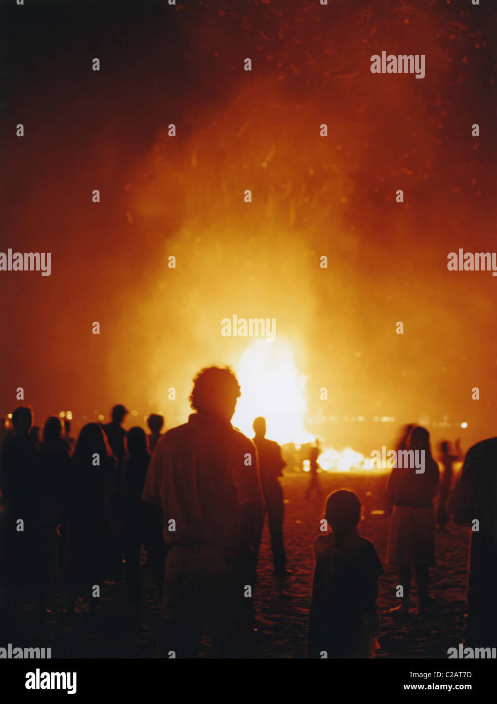 Crowd of people watching New Year's Eve bonfire on beach, Salinas ...