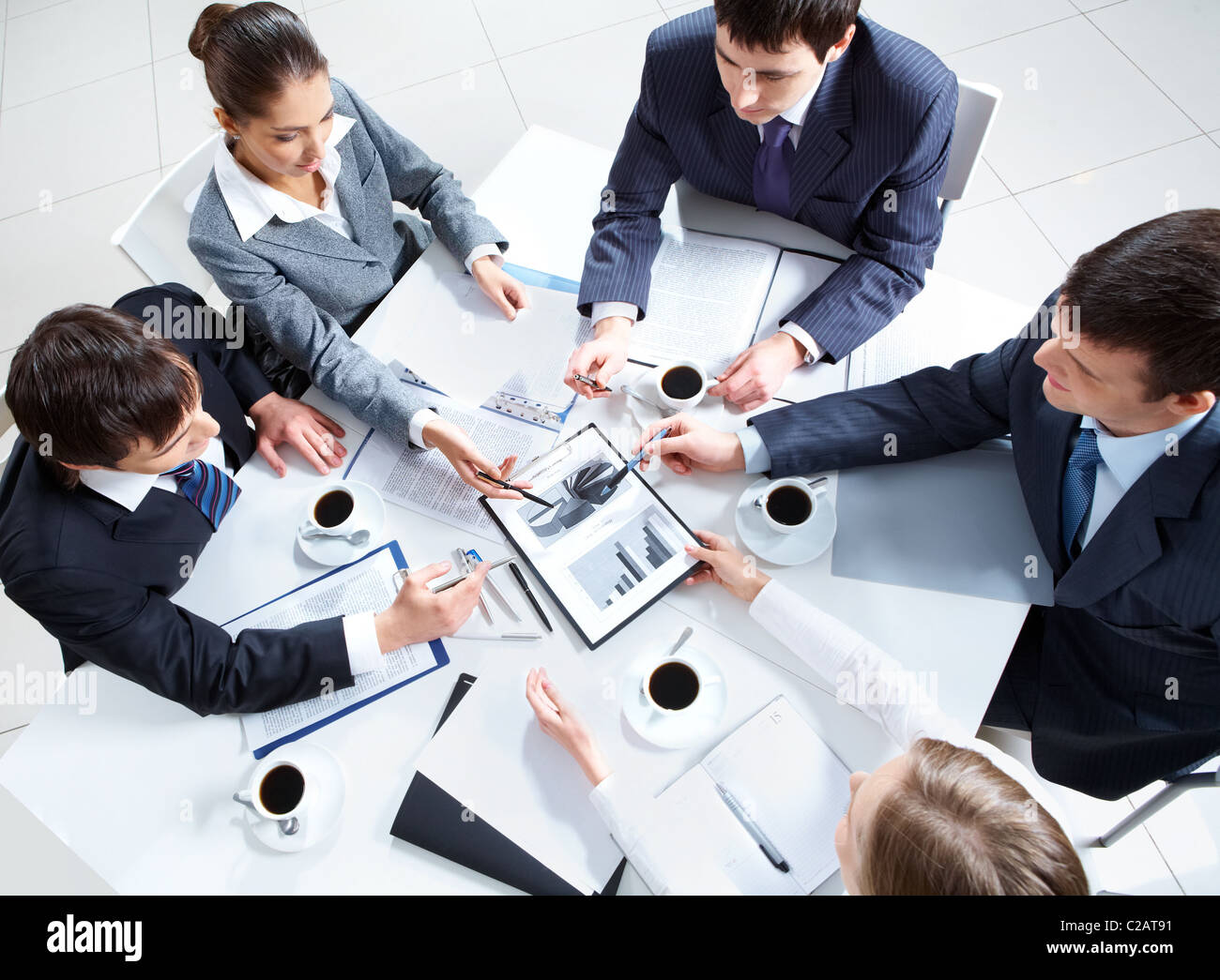 Above view of business team discussing papers at meeting Stock Photo ...