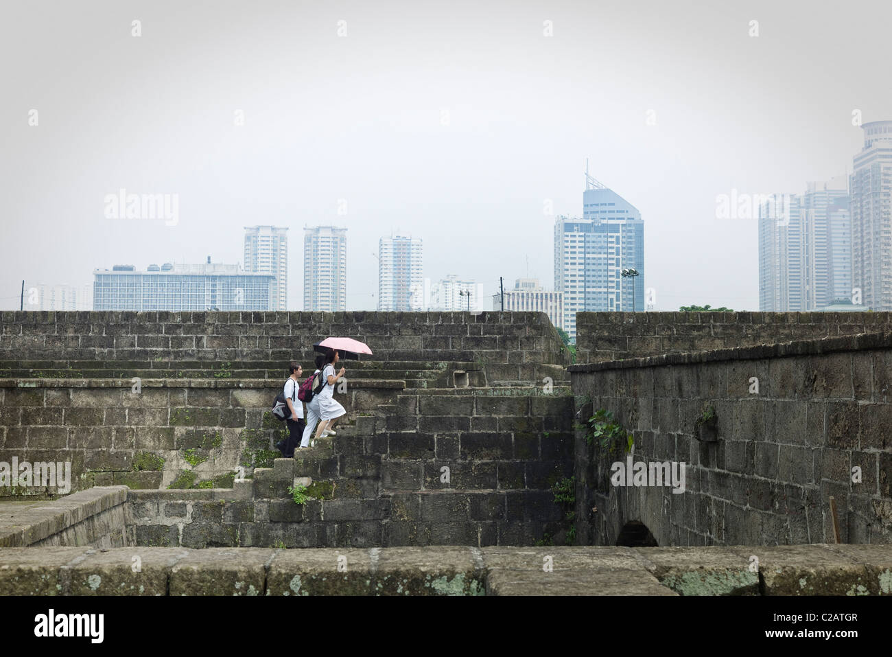 Philippines, Luzon, Manila, pedestrians walking up steps, city skyline ...