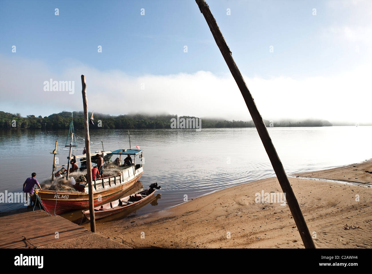 South America, Amazon, fishermen getting fishing boat into river Stock ...
