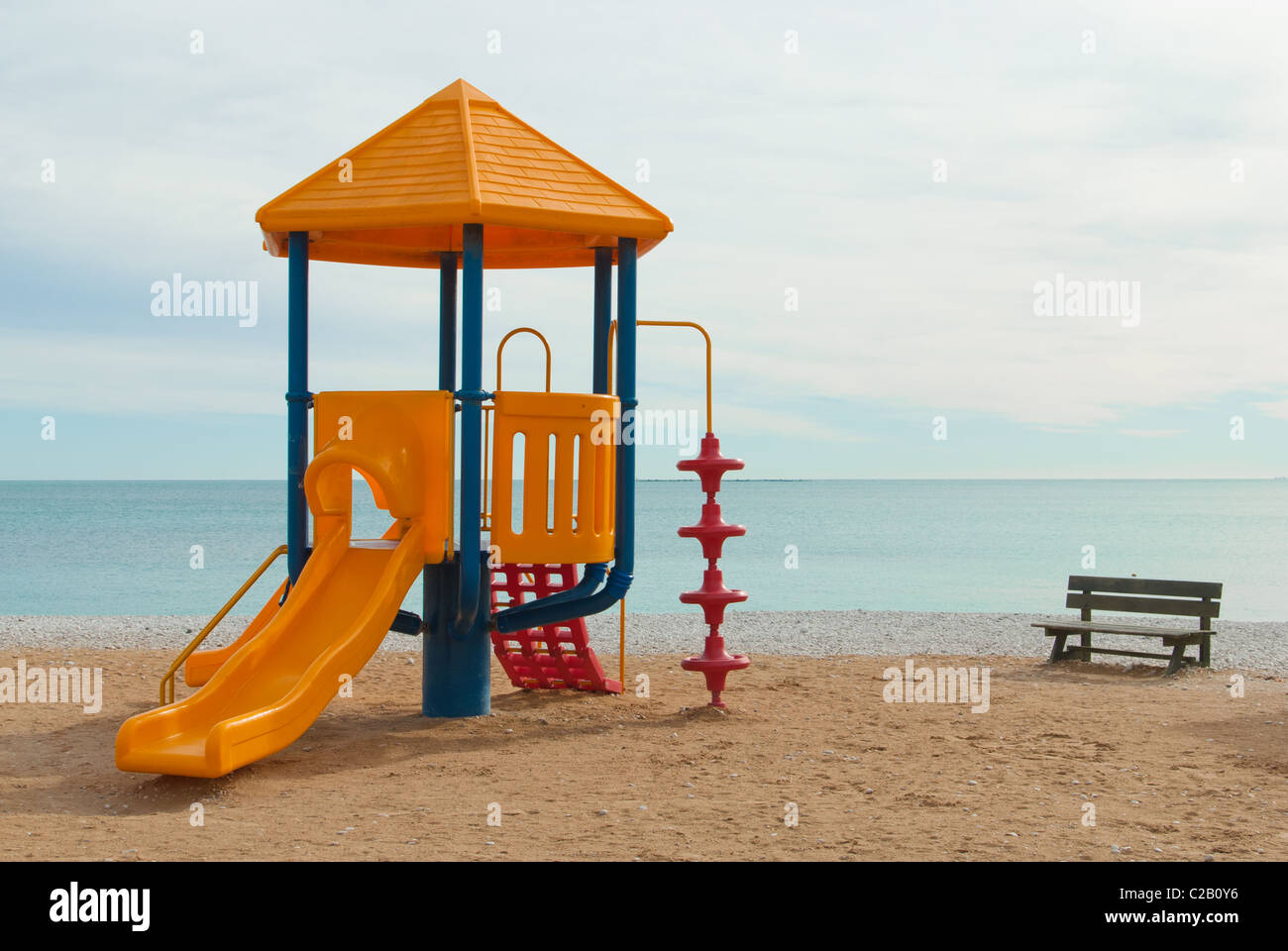 Colorful plastic chute on a beach playground Stock Photo - Alamy
