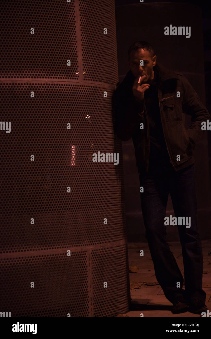 Man smoking outside at night Stock Photo - Alamy