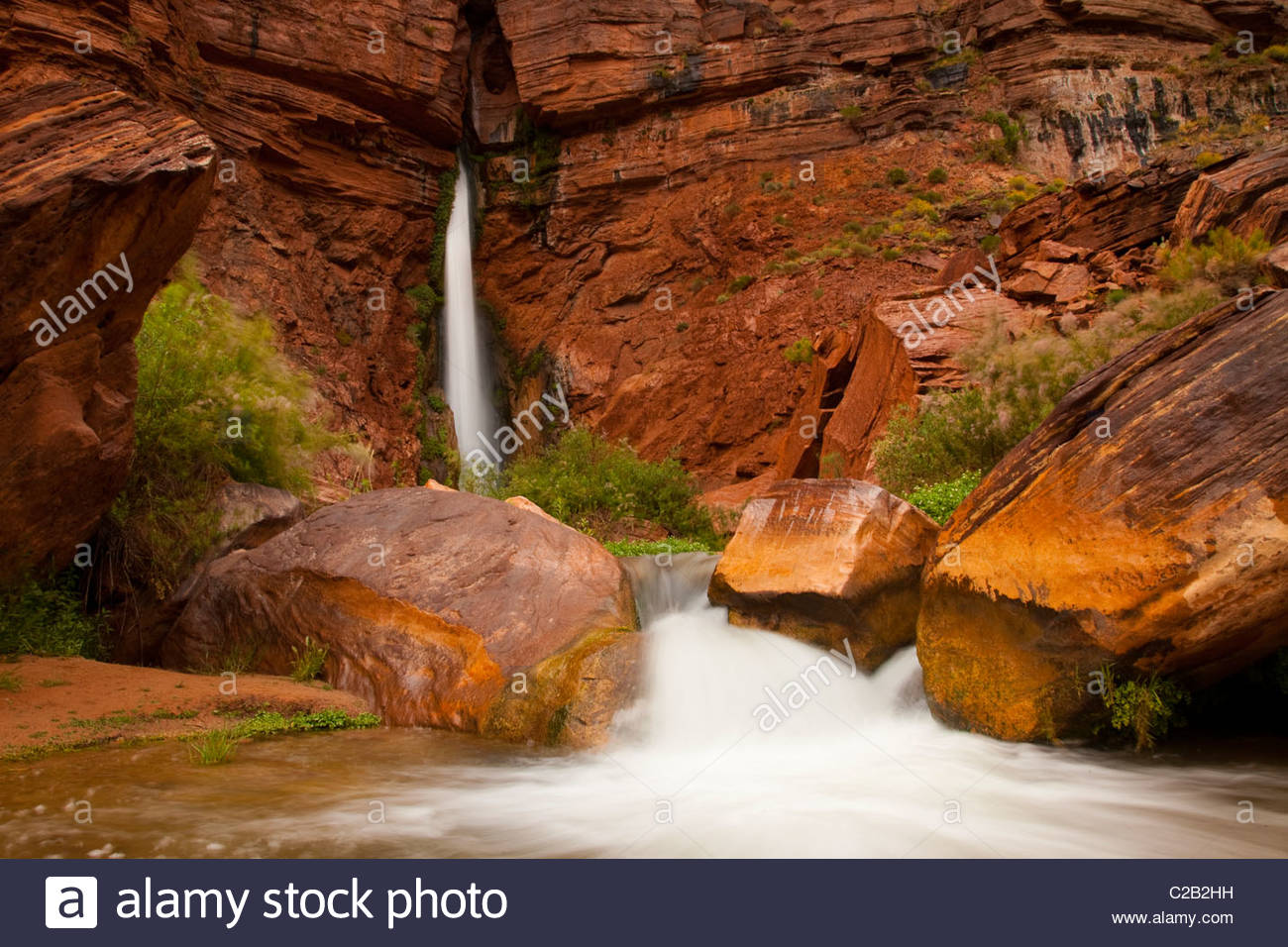 Waterfall from a narrow crevass in a sandstone cliff Stock Photo - Alamy
