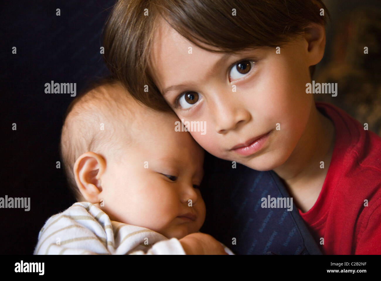 Brother with his baby sibling, portrait Stock Photo - Alamy