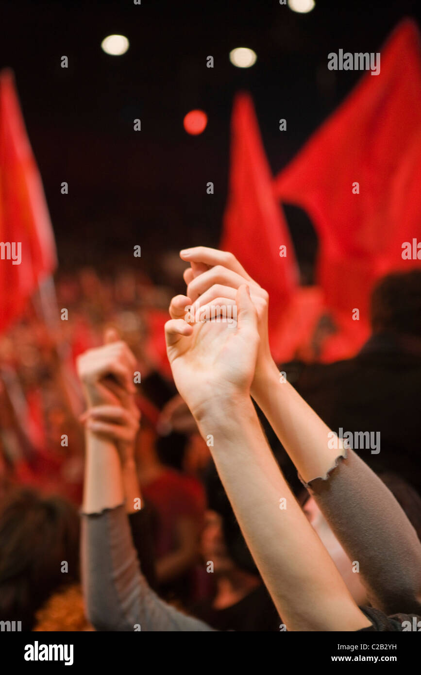 Large group of fans holding up arms hi-res stock photography and images ...