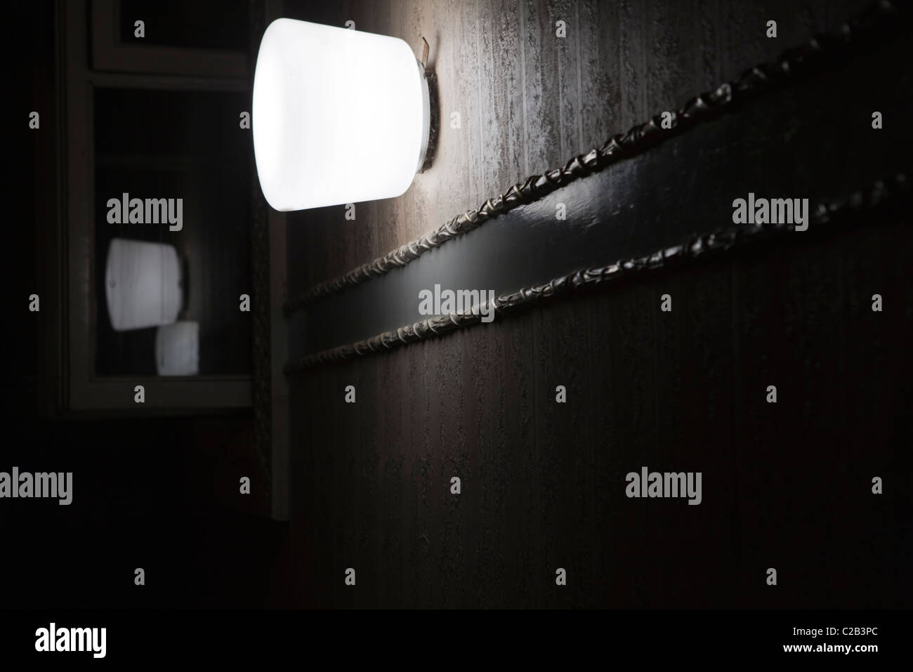 Illuminated lamp in dark room Stock Photo - Alamy