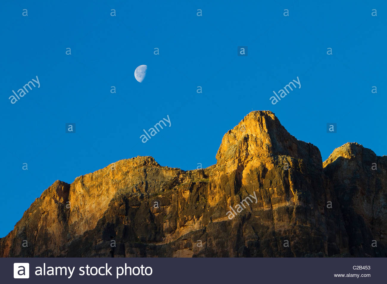 The moon shines over a desert cliff Stock Photo - Alamy