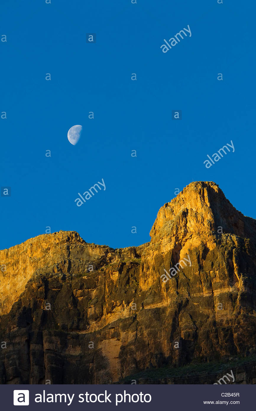 The moon shines over a desert cliff Stock Photo - Alamy