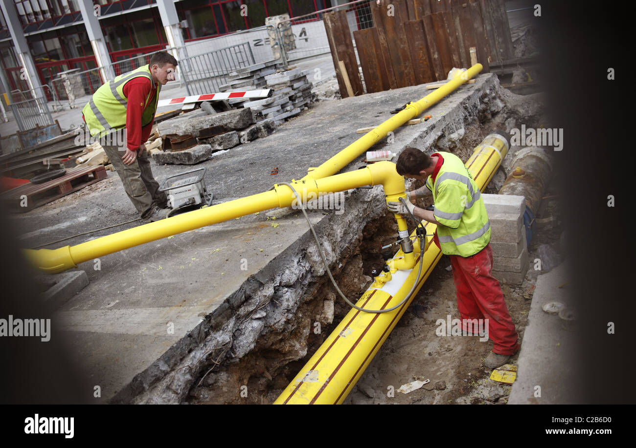 Workmen fitting new gas main pipes Stock Photo - Alamy