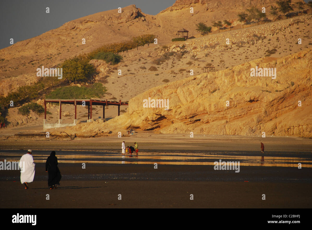Oman, Sawadi, view of a man in traditional dress looking at a person in ...