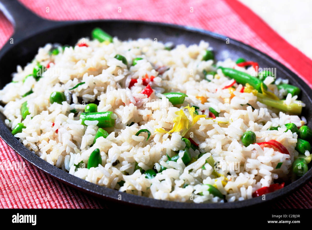 Fried rice in a black skillet - detail Stock Photo - Alamy