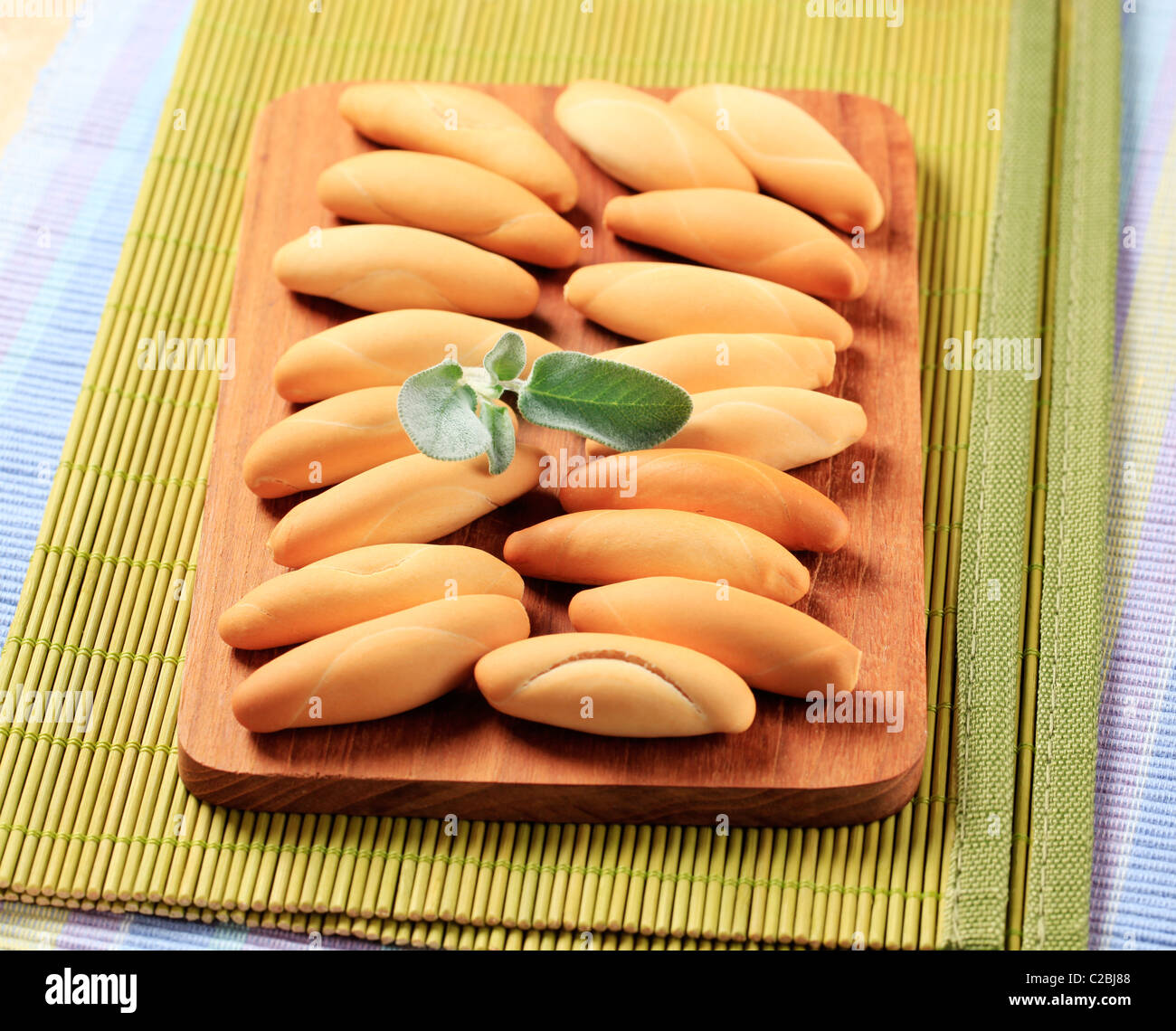 Crispy white rolls on a cutting board Stock Photo - Alamy