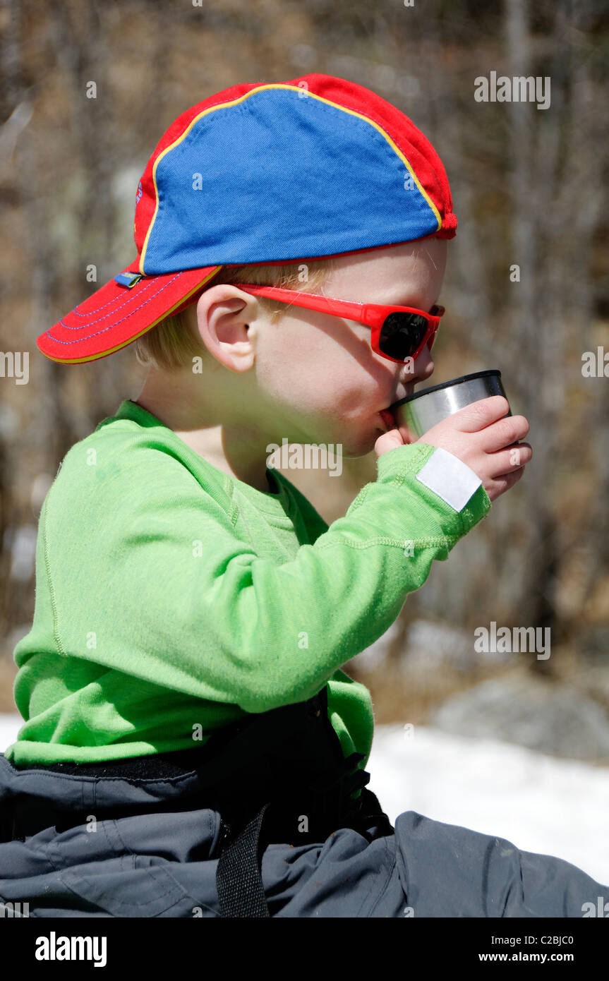 A young boy drinking tea from a flask Stock Photo - Alamy