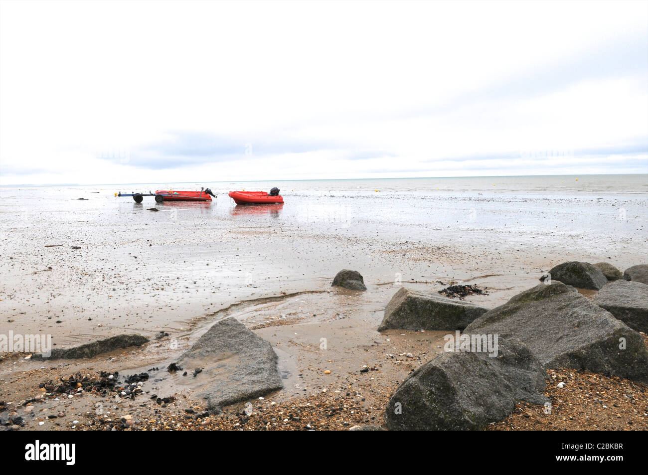 Two red boats on Normandy beach in the Summer Stock Photo - Alamy