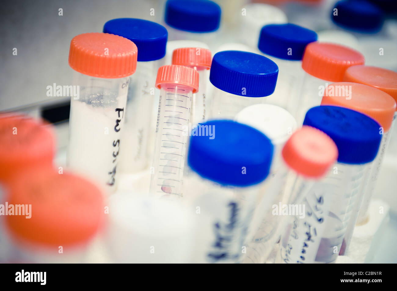 Close up shallow depth of field test tubes with bright blue and orange ...