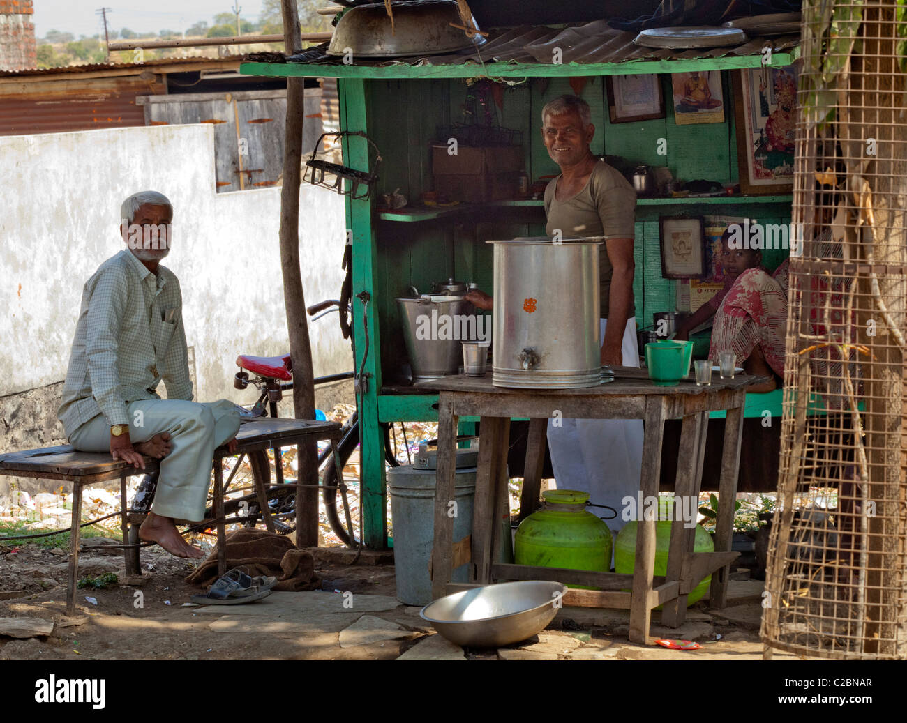 Men sitting at a stall selling chai in the Indian village of Valsang ...