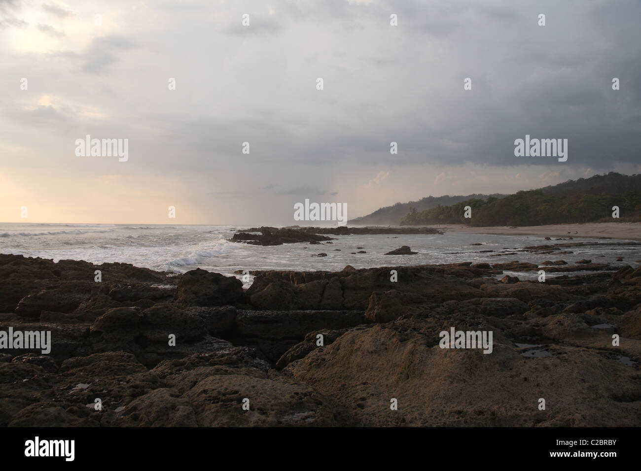 Shoreline and coral rocks on the beach at Santa Teresa, Costa Rica at ...