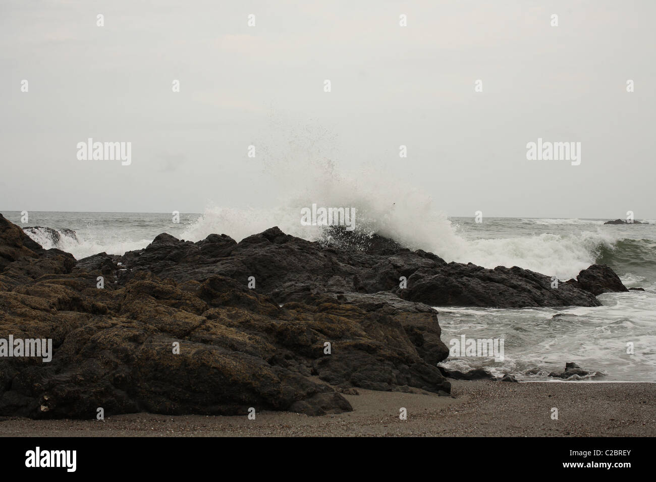 Wave crashing against rock on the beach hi-res stock photography and ...