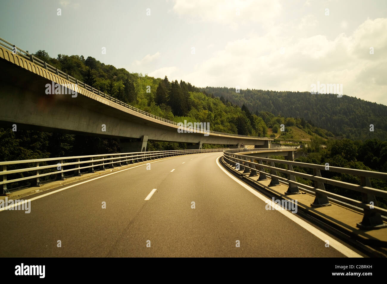 EMPTY MOTORWAY WITH MOUNTAINS IN THE BACKGROUND Stock Photo - Alamy