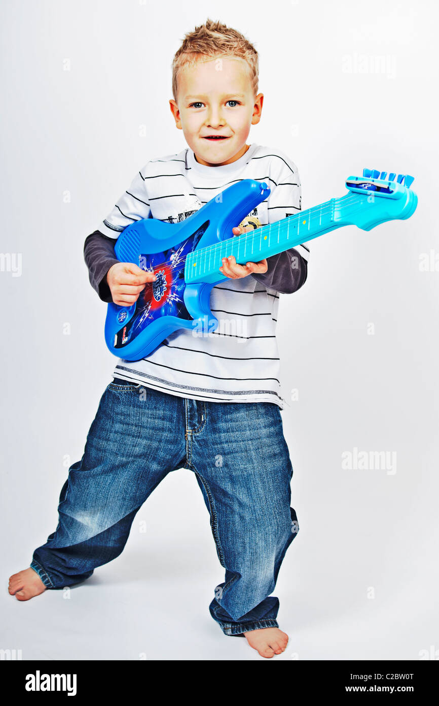 little happy boy playing his blue guitarr Stock Photo - Alamy
