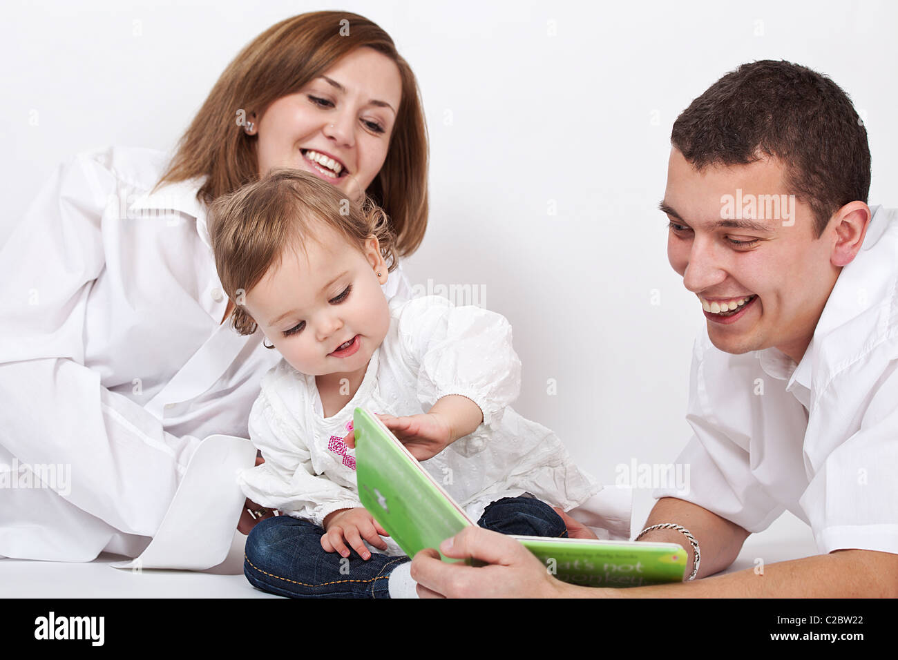 happy family reading book Stock Photo - Alamy