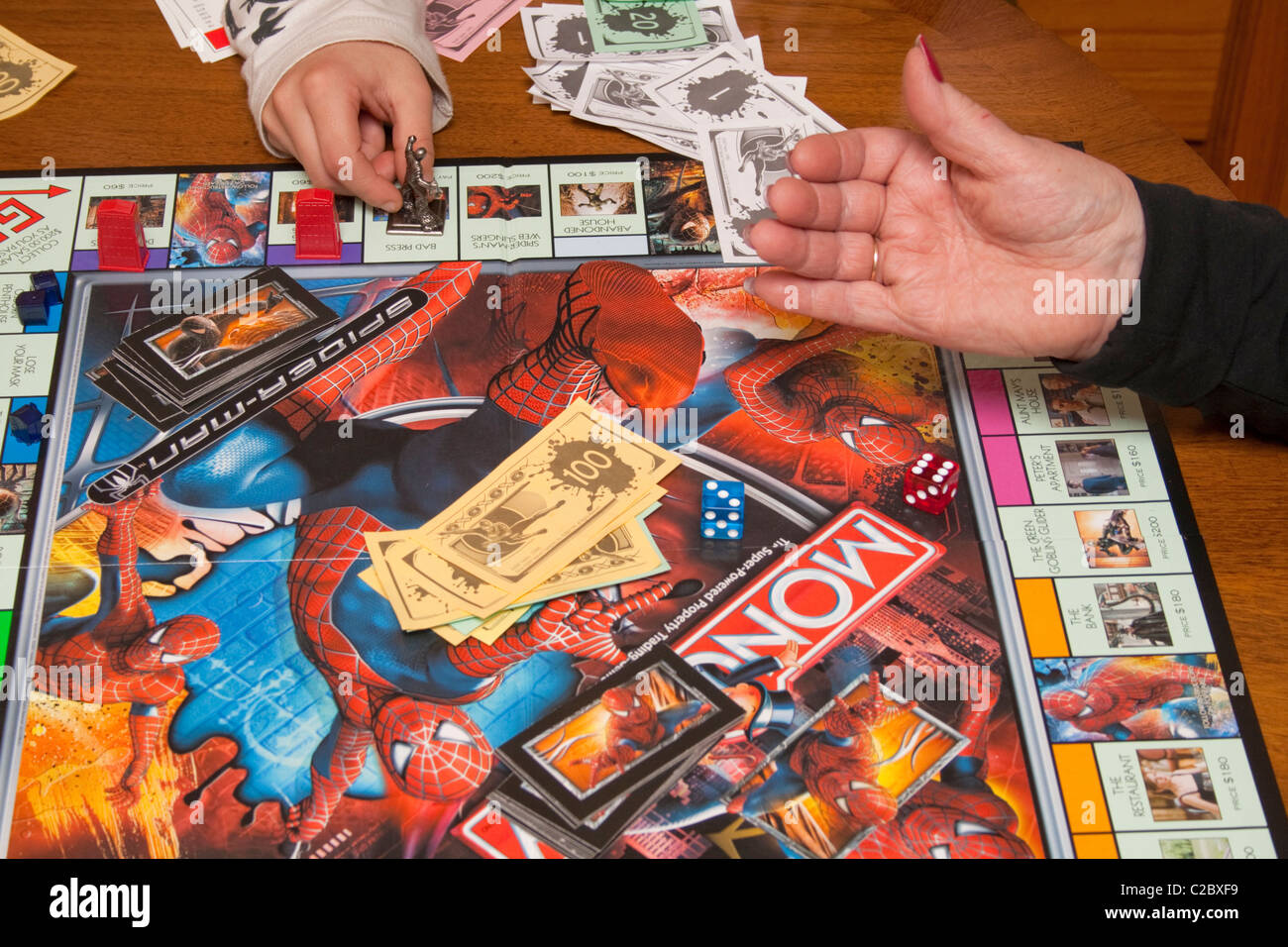 Tossing dice Spiderman Monopoly board game in progress. St Paul ...