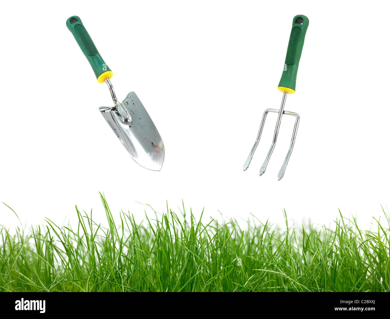 Green grass and garden tools siolated against a white background Stock ...