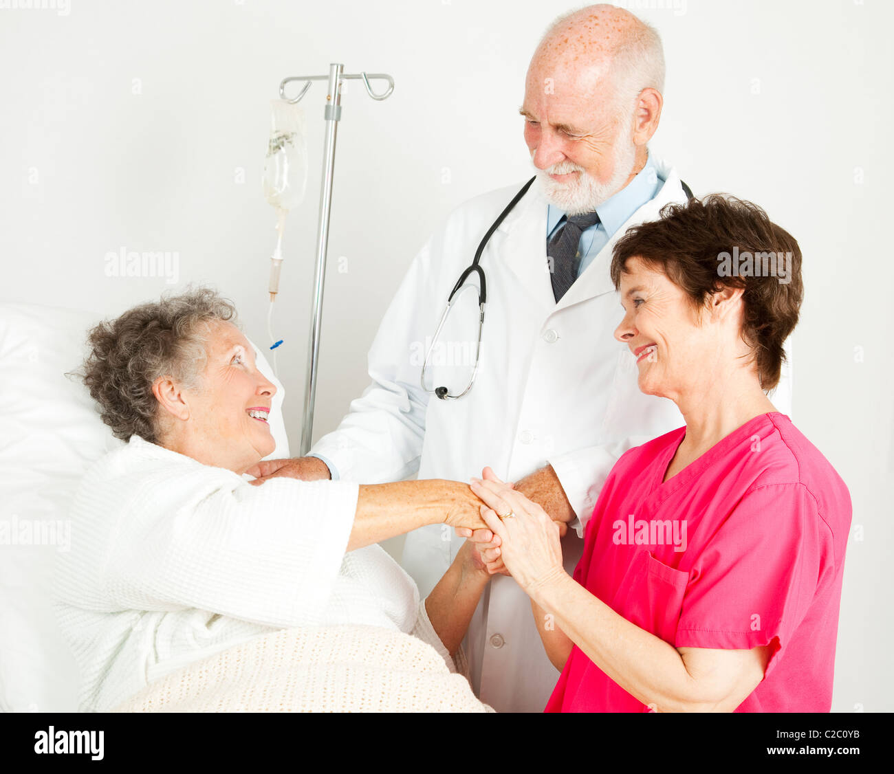 Caring doctor and nurse greeting hospital patient Stock Photo - Alamy