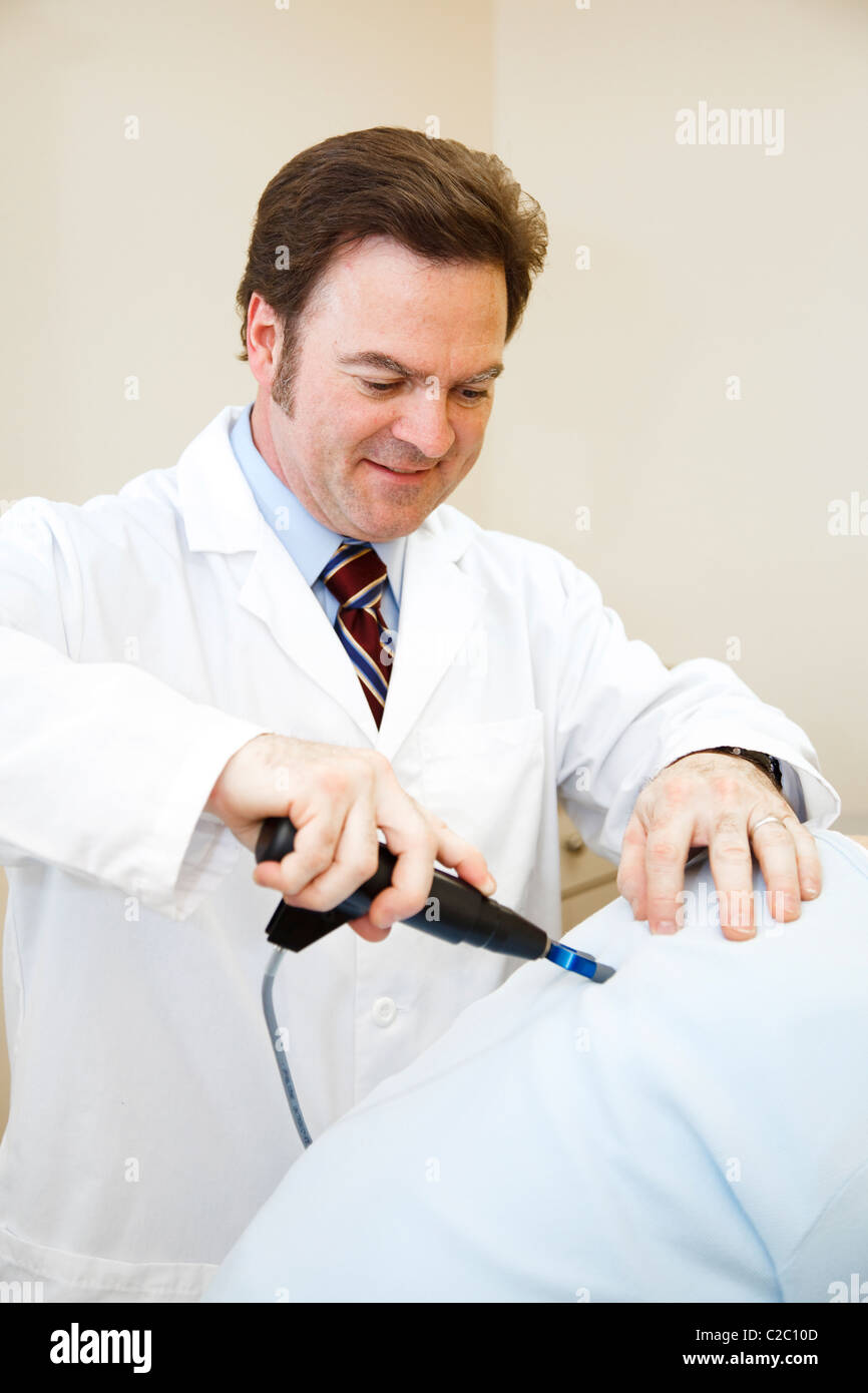 Chiropractor using a digital tool to adjust a patient's back Stock ...