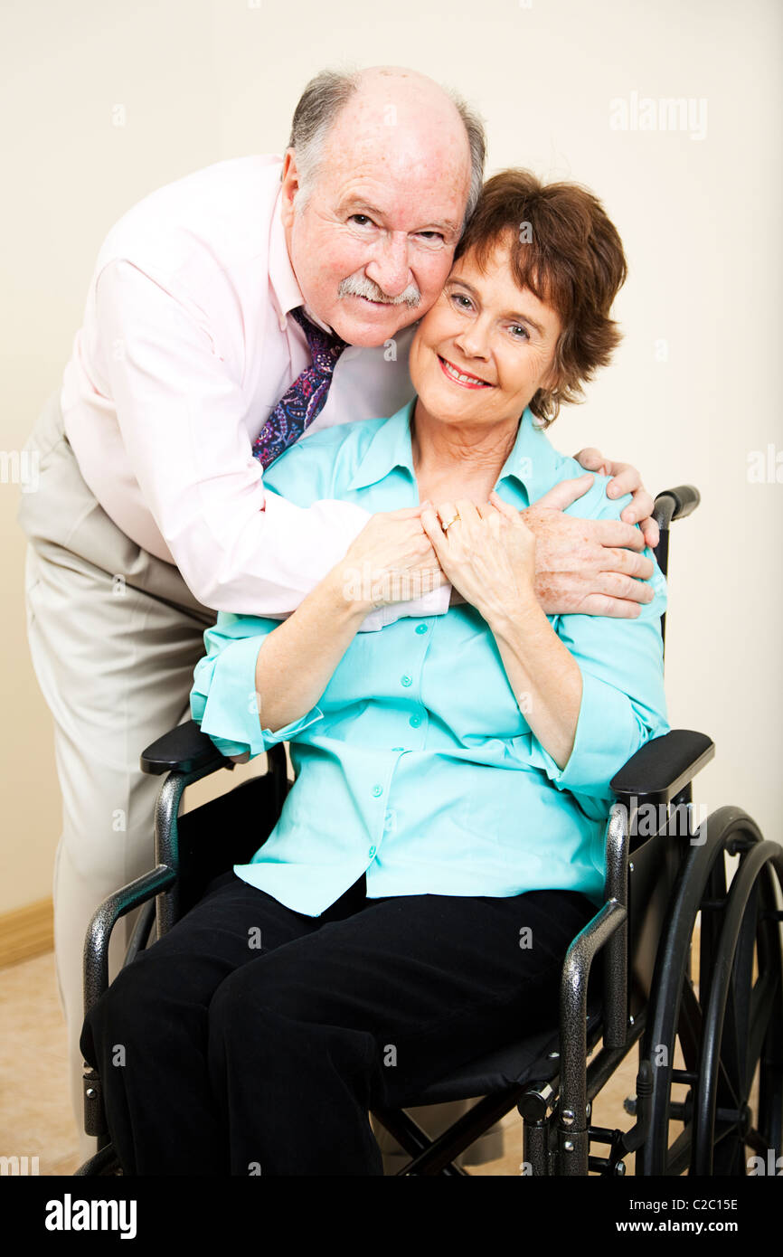 Loving, supportive husband gives his disabled wife a hug Stock Photo ...