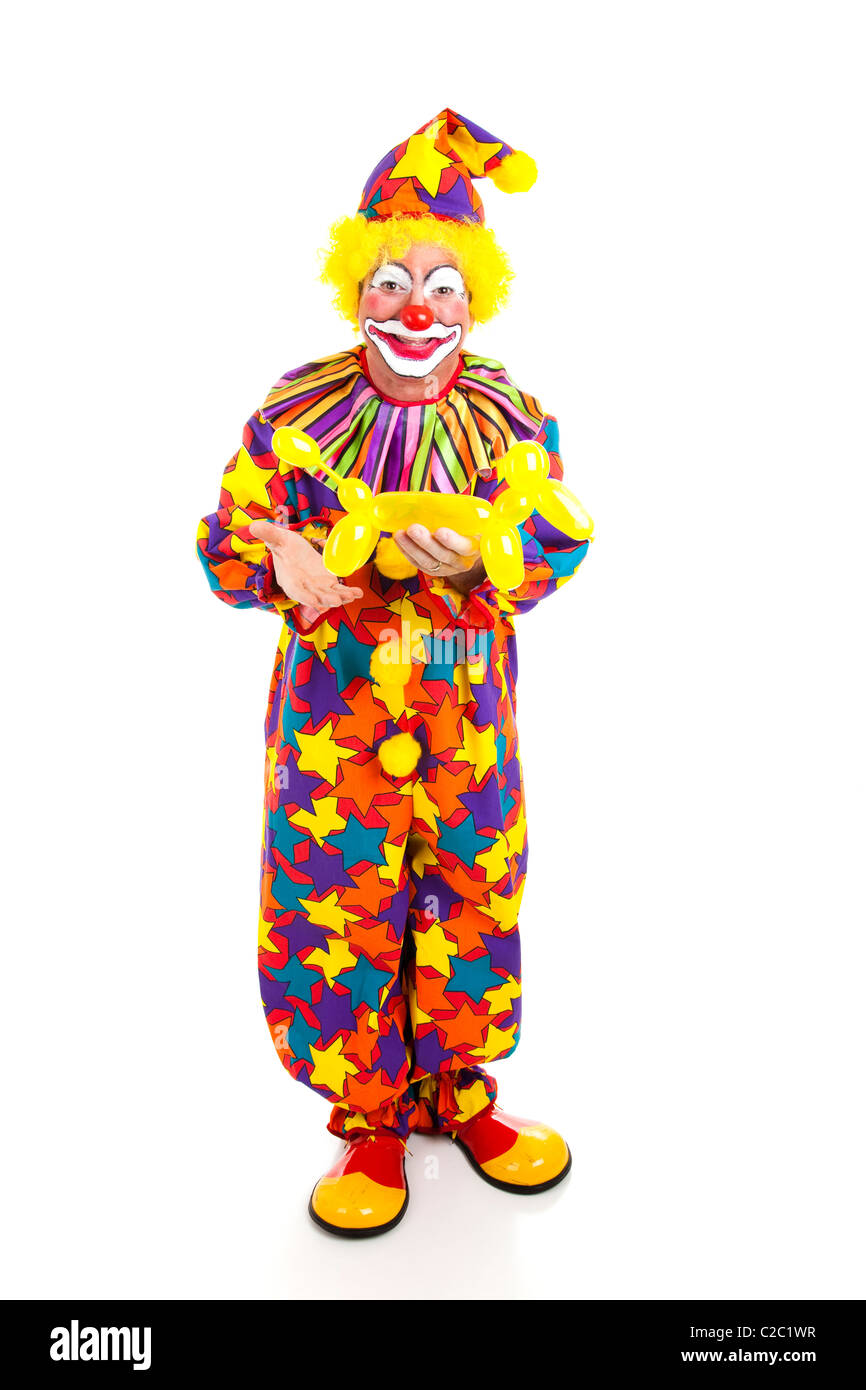 Full body isolated view of a birthday clown holding a balloon animal ...