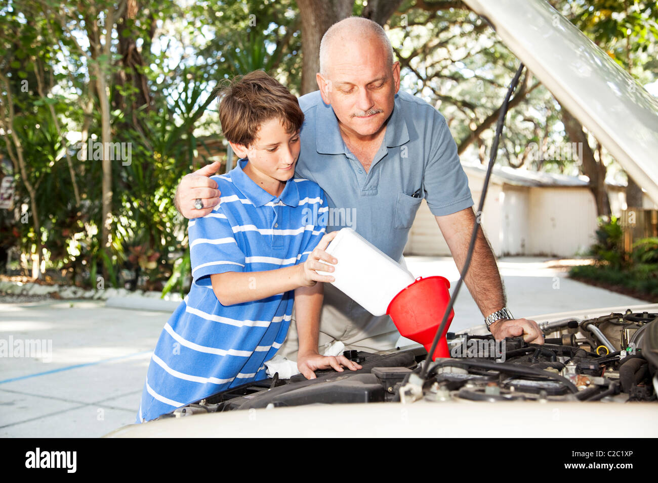 Father and son changing the motor oil in the family car Stock Photo - Alamy