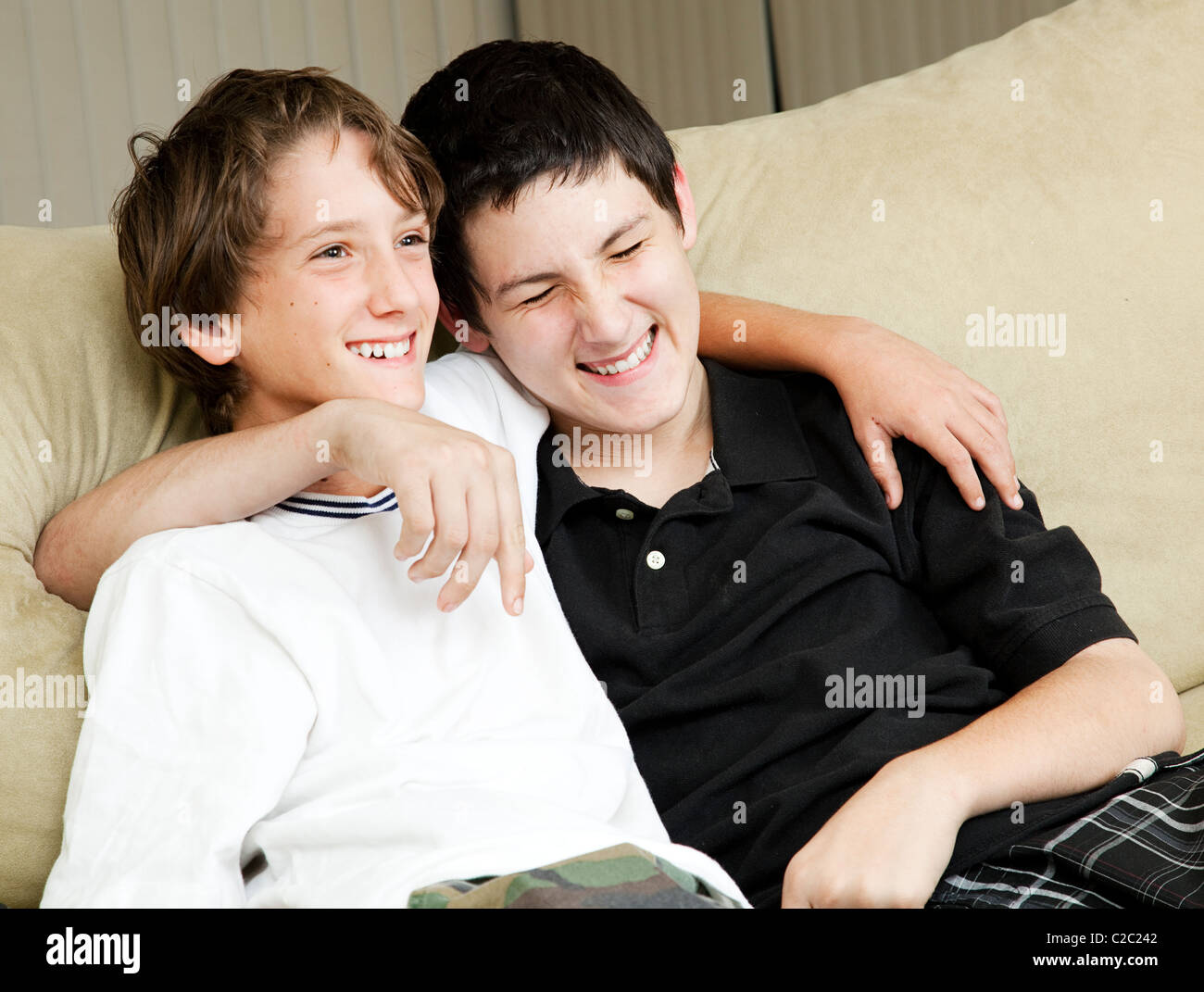 Two young brothers laughing together at home Stock Photo - Alamy