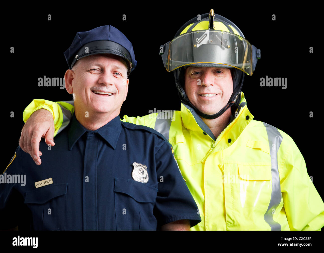 Portrait of happy, smiling police officer and fire fighter on black ...