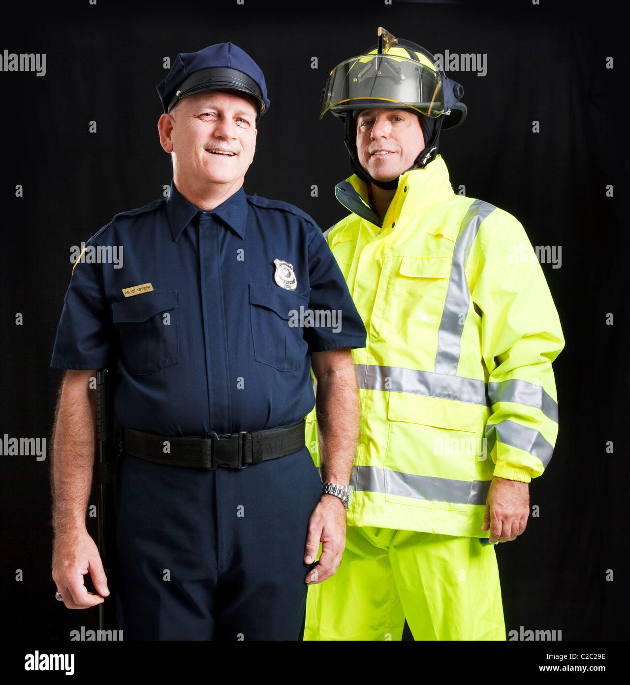 Police officer and firefighter photographed together over a black ...