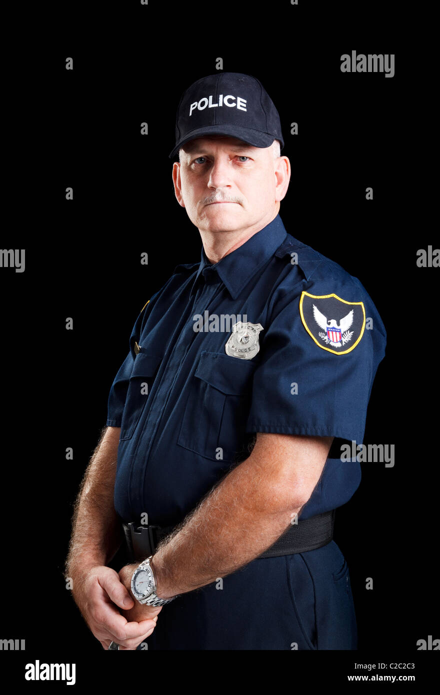 Serious portrait of a policeman on a black background Stock Photo - Alamy