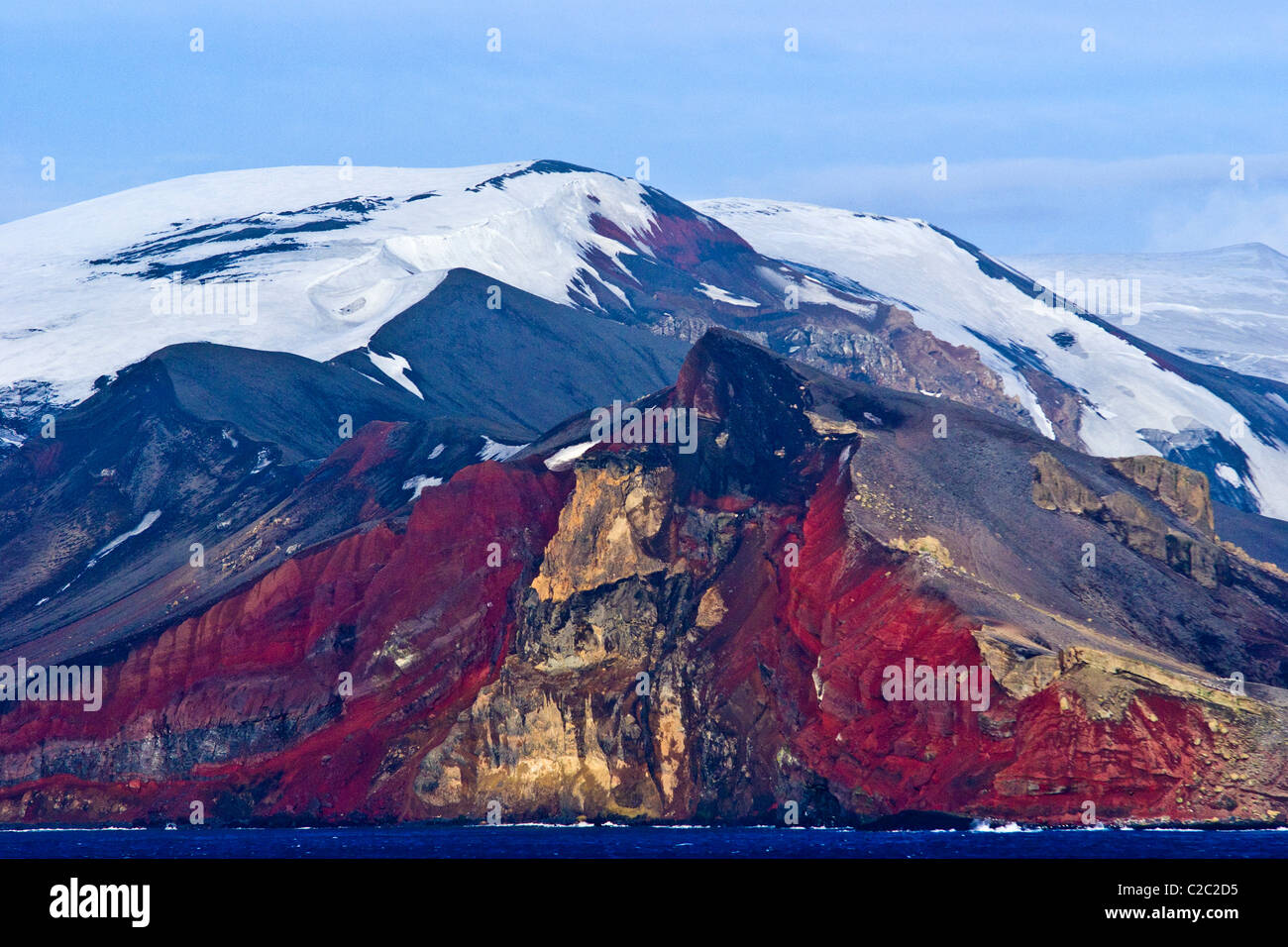 Rugged snow and ice encrusted mountain surrounding a volcanic caldera ...